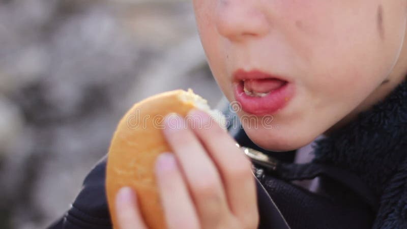 An Orphan Boy Close-up Eating Bread and Holding Stock Footage - Video ...