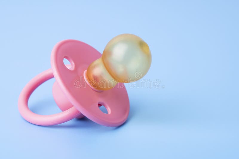 Orthodontic Pacifier on a Blue Background. Pink Baby Pacifier on a Blue ...