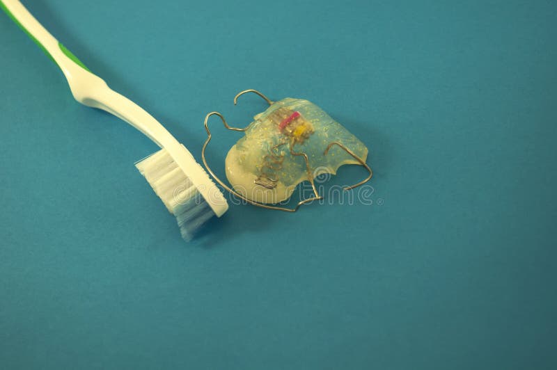 Orthodontic Retainer and Toothbrush on Blue Background Stock Image ...