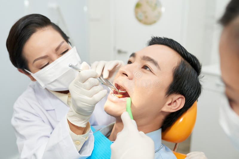Orthodontist Checking Teeth Stock Photo - Image of dentistry, dentist ...