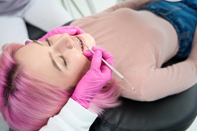 Orthodontist Performs Maintenance of a Bracket System for Teeth ...