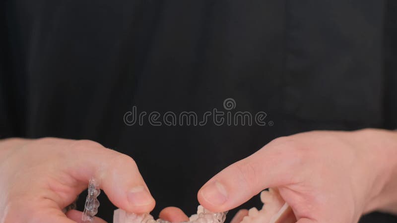 An Orthodontist Talks about the Correction of Teeth while Holding a ...