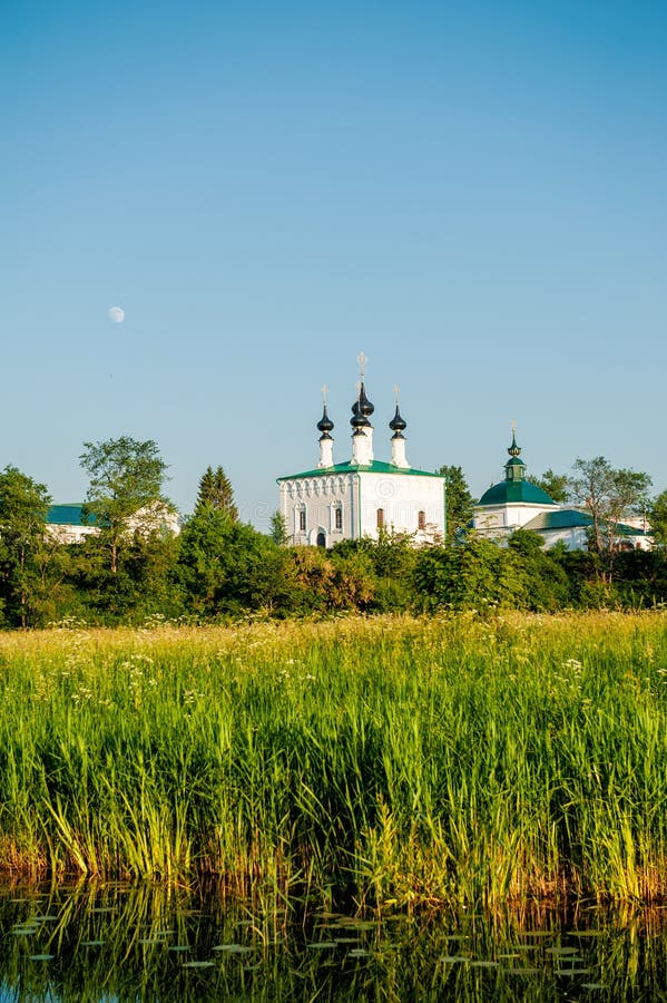 Orthodox Church with Black Domes Reflects in a River Surrounded by ...