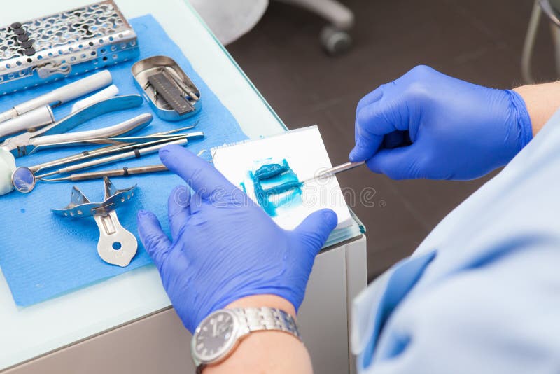 An Orthopedist Dentist Prepares a Polymer Material for Making a Dental ...