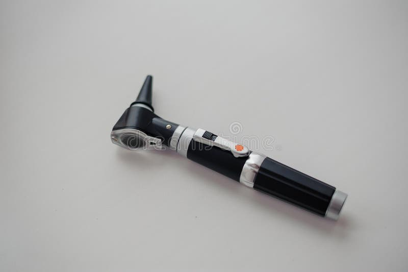 Otoscope on a White Background in the Hand of an Otolaryngologist ...