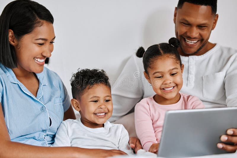 Our Family Time is Everything. a Young Family Using a Digital Tablet at ...