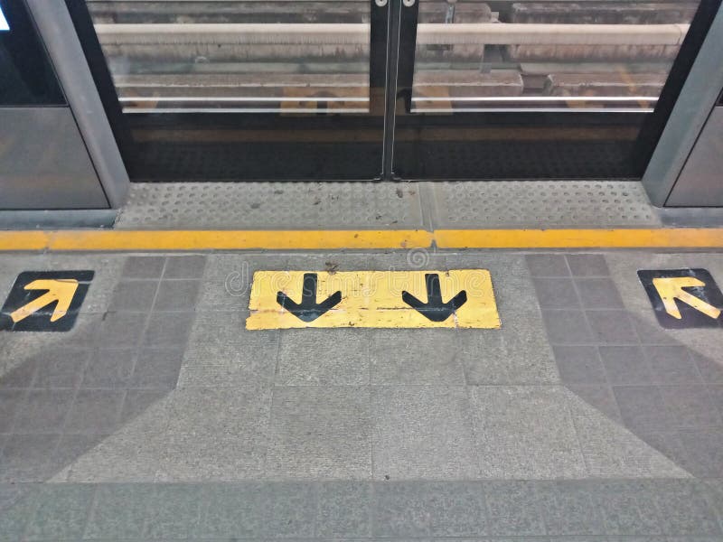 In and Out Arrow Sign for Queue at Train Station Stock Image - Image of ...
