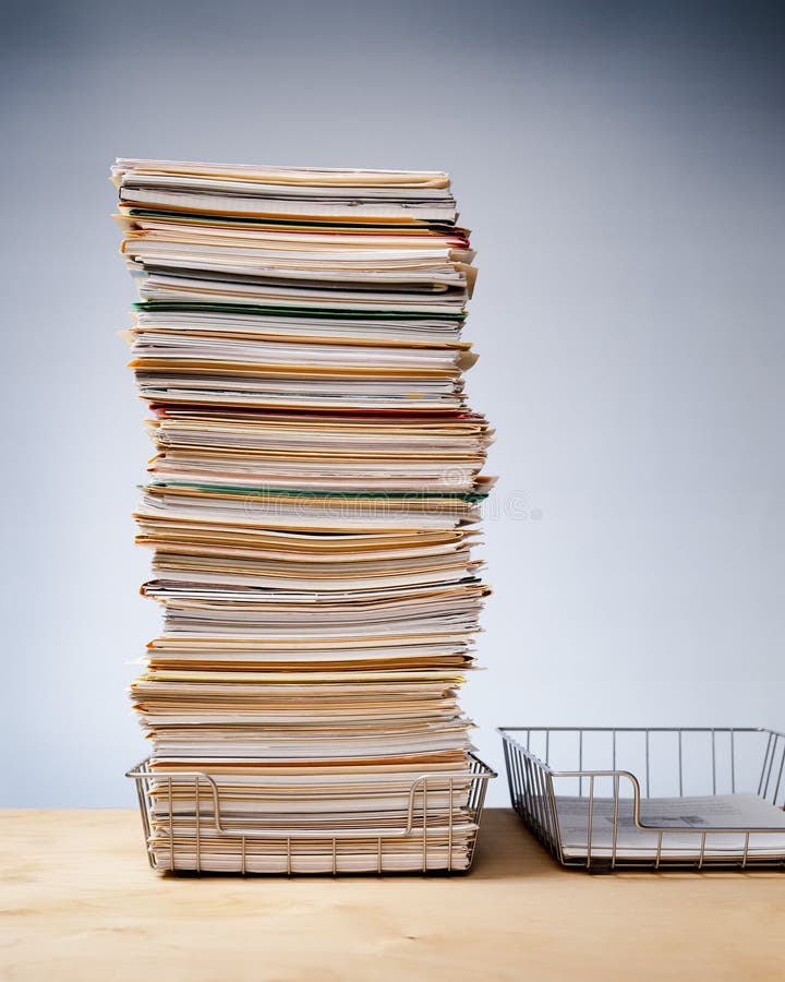 Trays on Desk with Ambitious Stack of Never Ending Pape Rwork Stock ...