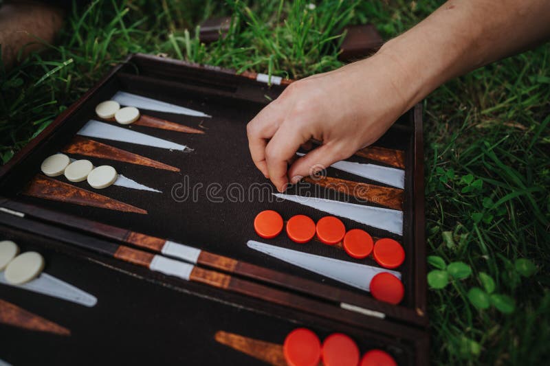 Outdoor Backgammon Game with Hand Making a Strategic Move Stock Photo ...
