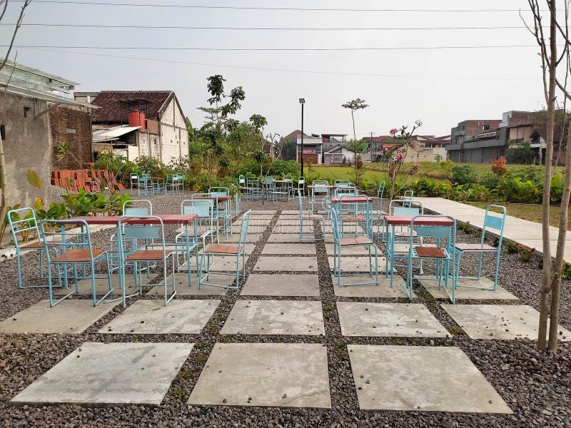 A Collection of Tables and Chairs in the Courtyard of a Cafe Stock ...