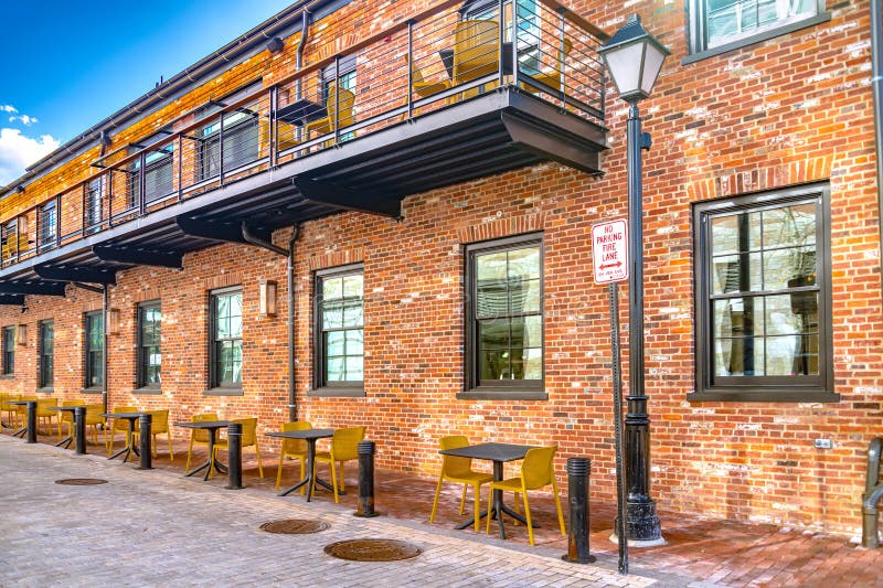 Outdoor Cafe. Empty Tables and Chairs Along the Brick Wall Stock Photo ...