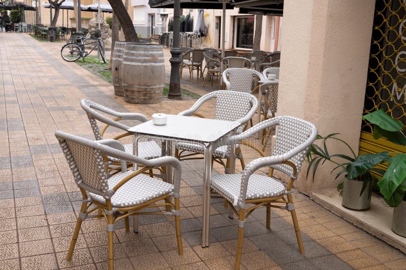 Outdoor Cafe Setting with Empty Chairs and Table on a Quiet Urban ...