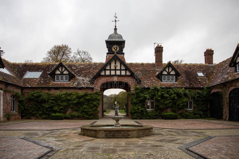 A Courtyard with a Fountain and Clock Tower in the Background Editorial ...