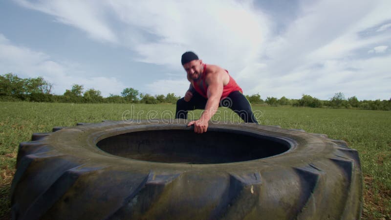 Outdoor CrossFit Workout Muscular Man Pulling the Wheel Stock Footage ...