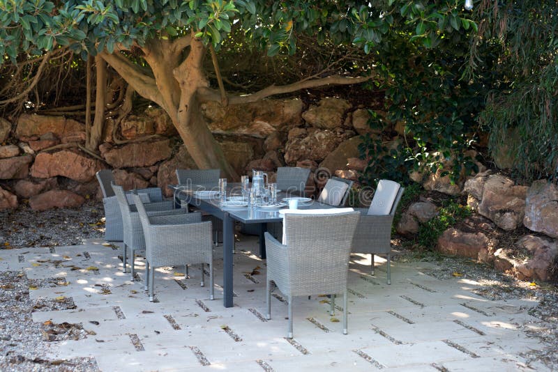 Outdoor Dining Area Under the Shelter of a Large Tree Stock Image ...