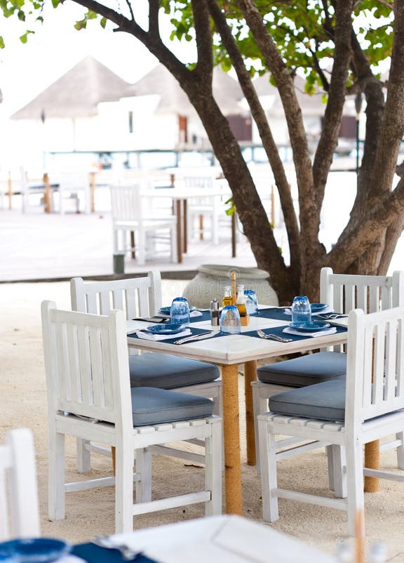 Outdoor Dining Tables on the Sand Beach Stock Image - Image of ...