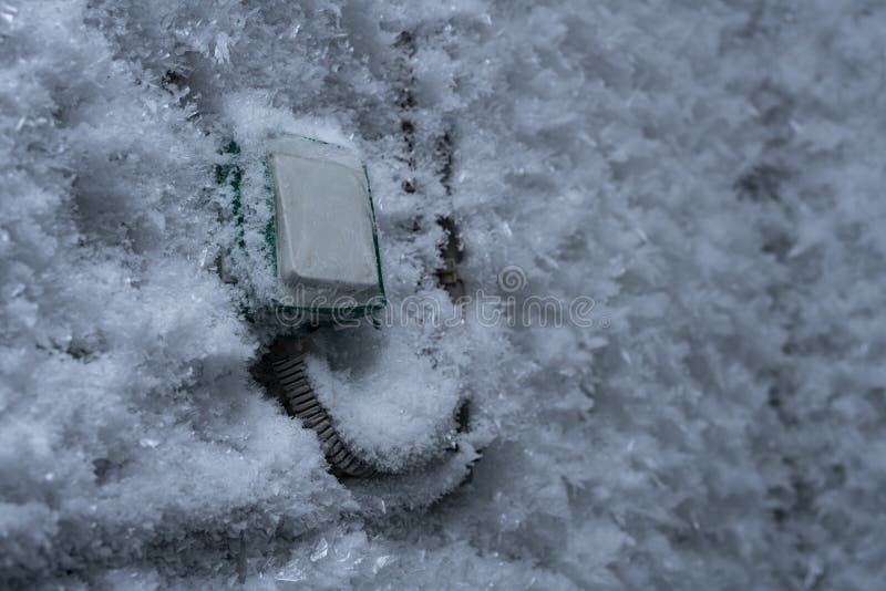 Snow Covered Device with Switch on Frozen Wall in Winter Stock Photo ...