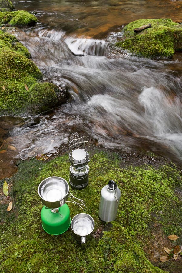 Outdoor Equipment beside Brook Stock Photo - Image of lighting, bottle ...