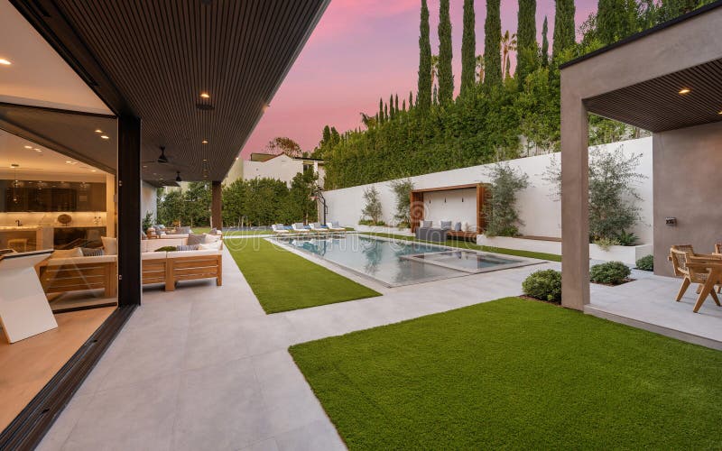 Outdoor Patio Adjacent To a Sparkling Pool in the Backyard Stock Photo ...