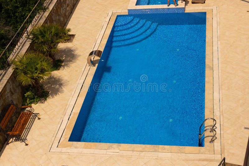 Pool with Blue Water Ladder for Descent and Ascent into the Water. the ...