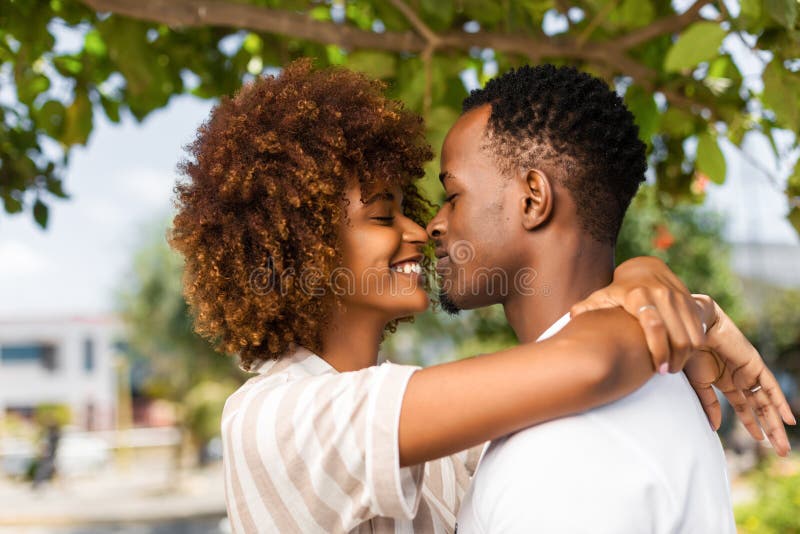 Outdoor Protrait Of African American Couple Kissing Each Other Stock