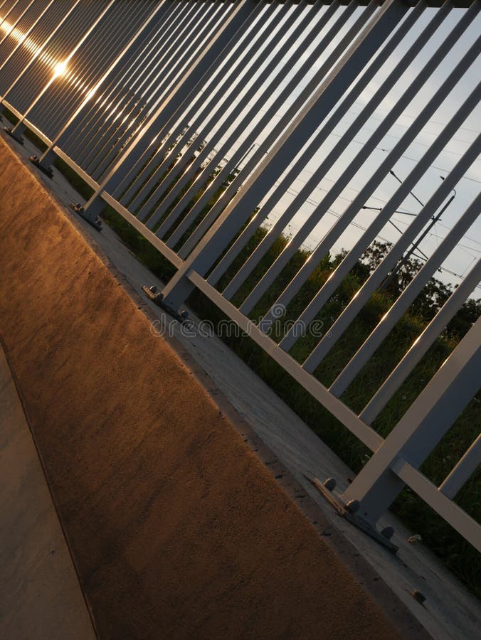 An Outdoor Railing at Sunset Stock Photo - Image of travel, horizon ...