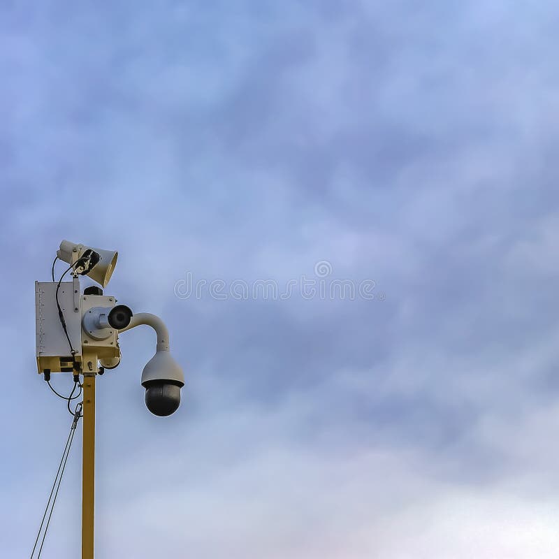 Outdoor Security Camera Isolated Against a Cloudy Blue Sky Background ...