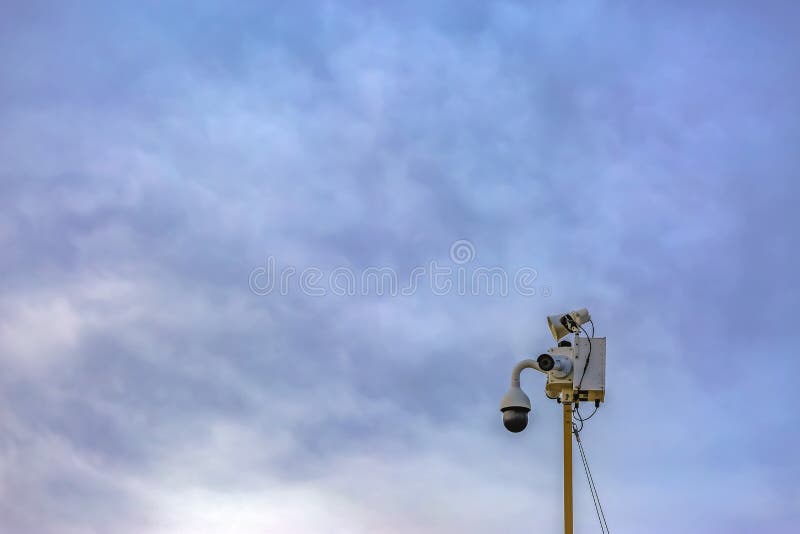 Outdoor Security Camera Isolated Against a Cloudy Blue Sky Background ...