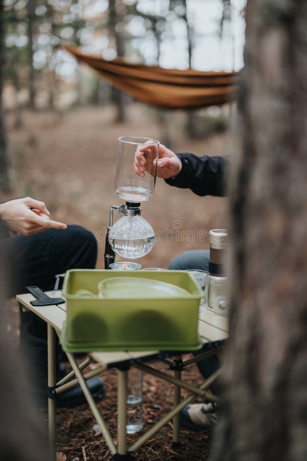 Outdoor Setup Featuring a Siphon Coffee Maker on a Picnic Table in a ...