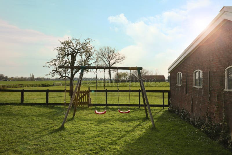 Outdoor Swings Near Building on Spring Day Stock Image - Image of field ...