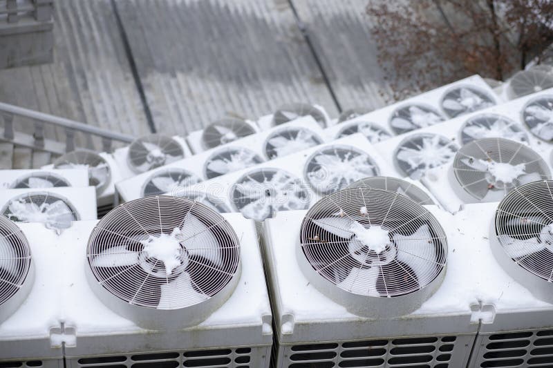 The Outdoor Unit of the Air Conditioner in the Snow during Winter Stock ...