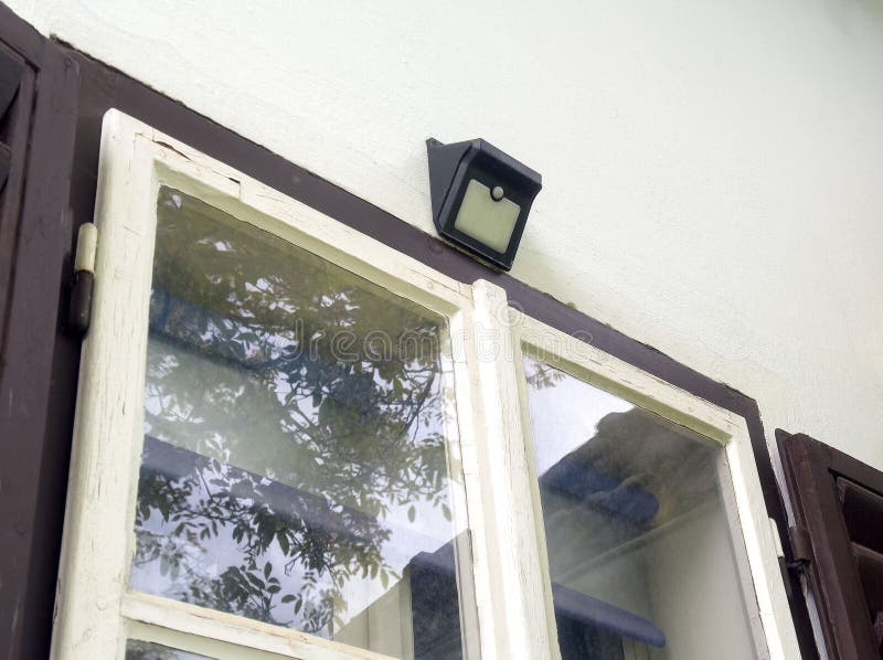 Outdoor Wall-mounted Motion Sensor Light Above Window with Reflections ...