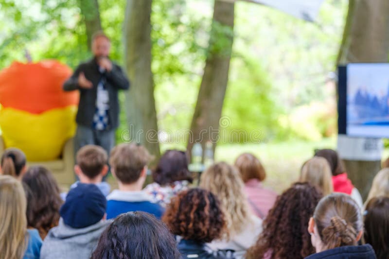 Outdoor Workshop with Diverse Audience in a Blurred Setting Stock Photo ...