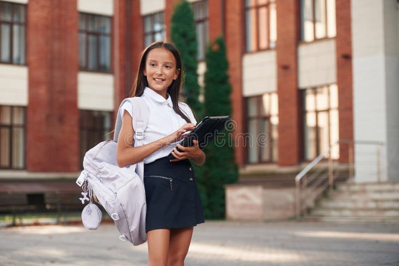 Outdoors Near the Building. School Girl in Uniform Stock Photo - Image ...