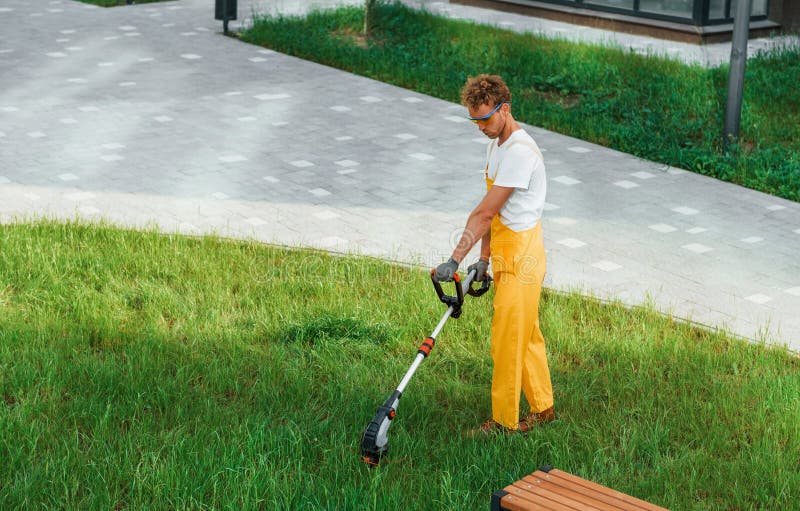 Outdoors in the Yard. Man Cut the Grass with Lawn Mover Stock Photo ...
