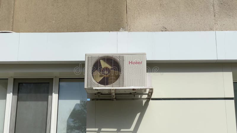 Outer Unit Rotating Fan of Air Conditioner on an Apartment Complex Wall ...