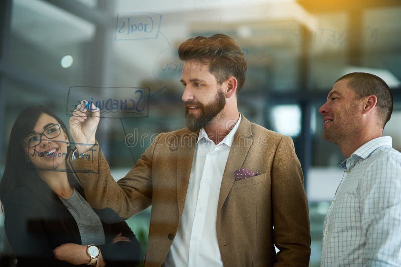 Outlining Their Core Concepts. a Group of Colleagues Brainstorming on a ...