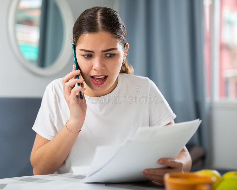 Outraged Woman Checking Price Tag on a Shoe in the Footwear Store Stock ...