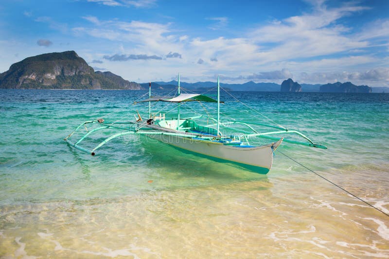 Outrigger Boat on a Tropical Beach Stock Photo - Image of horizon ...