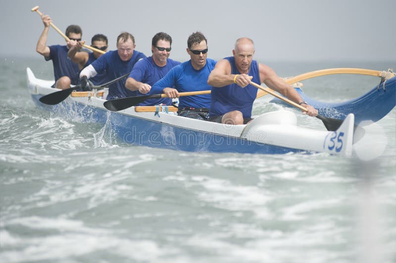 Outrigger Canoeing Team in Race Stock Photo - Image of determination ...