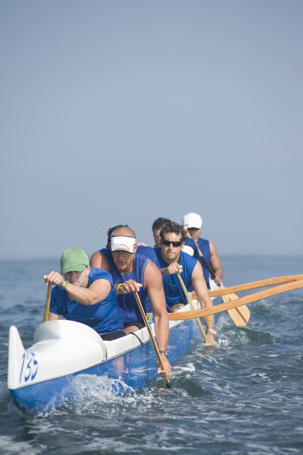 Outrigger Canoeing Team in Race Stock Image - Image of people, male ...