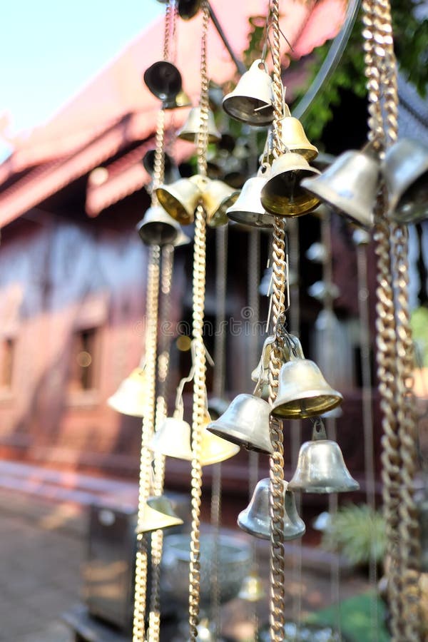 A Group of Small Bronze Bells Hanging from a Chain Stock Image - Image ...
