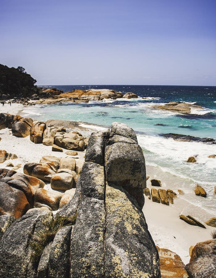 Outstretched Rock Looking Out Onto a Beach with Orange Rocks Stock ...