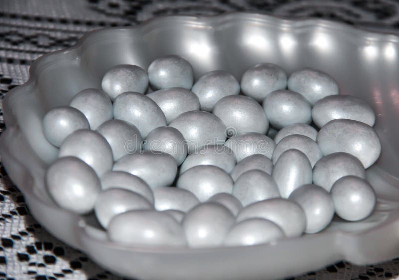 Oval Candies in a Shell on a Lace Tablecloth Stock Photo - Image of ...