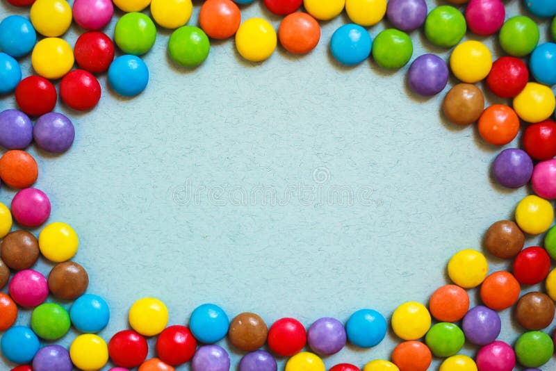 Oval Frame of Multi-colored Candies on Blue Background Stock Photo ...