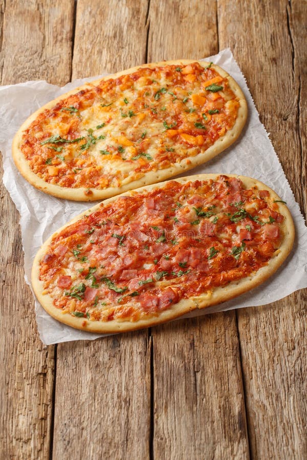 Oval Portion Pizza of Two Types Three Cheeses and Cheese with Ham Close ...