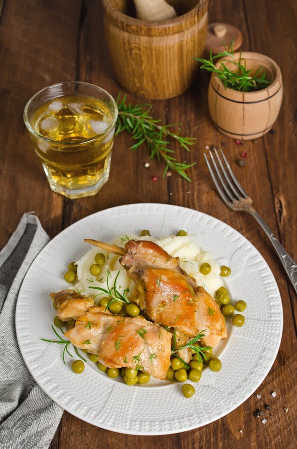 Oven Baked Rabbit Legs with Potatoes and Rosemary Stock Photo - Image ...