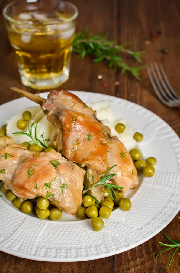 Oven Baked Rabbit Legs with Potatoes and Rosemary Stock Photo - Image ...