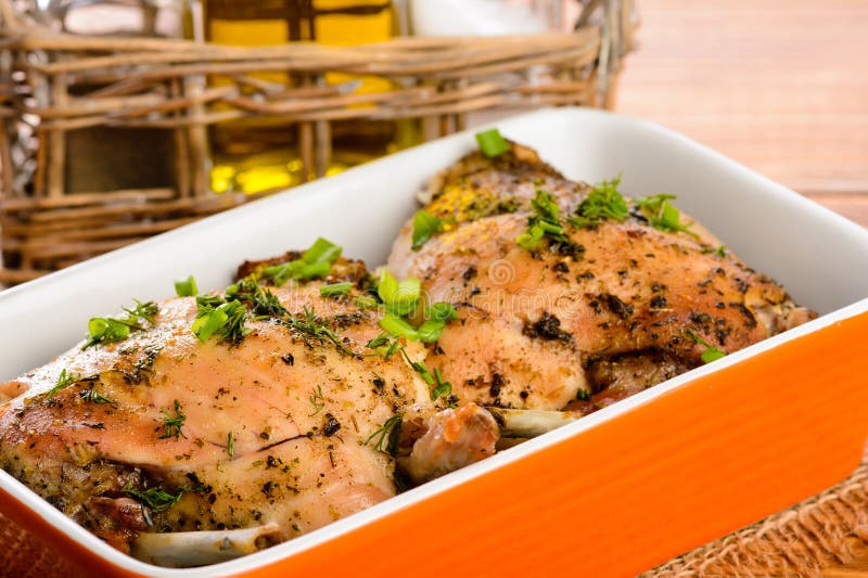Oven Baked Rabbit in Orange Ceramic Bowl on Brown Wooden Table. Stock ...