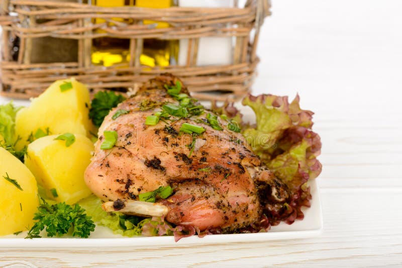 Oven Baked Rabbit with Potatoes on Wooden Table. Stock Image - Image of ...